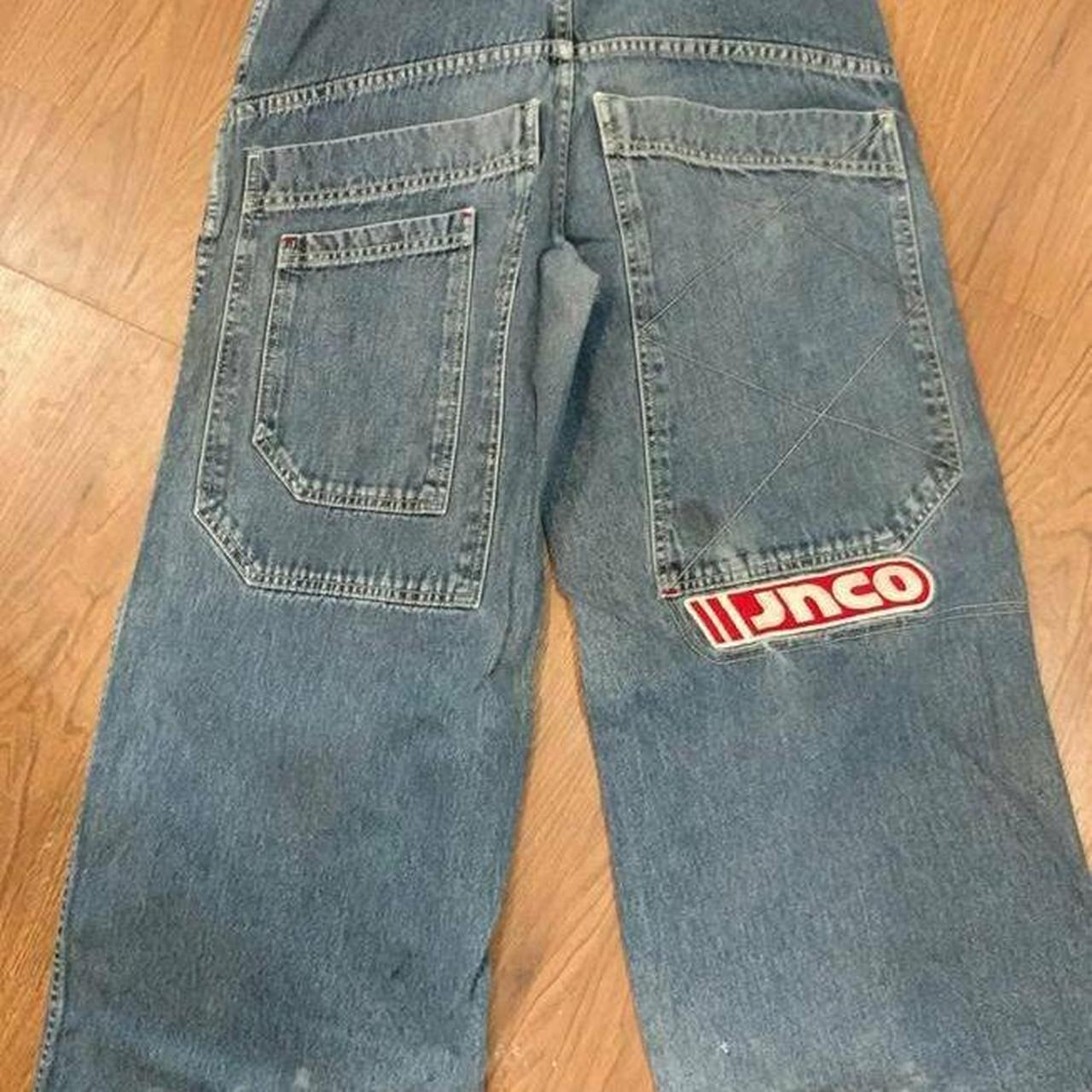 Blue JNCO jeans with a red logo on the back - Depop