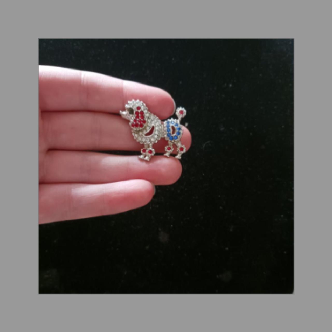 A Vintage poodle pin. Silver toned with red, white &... - Depop