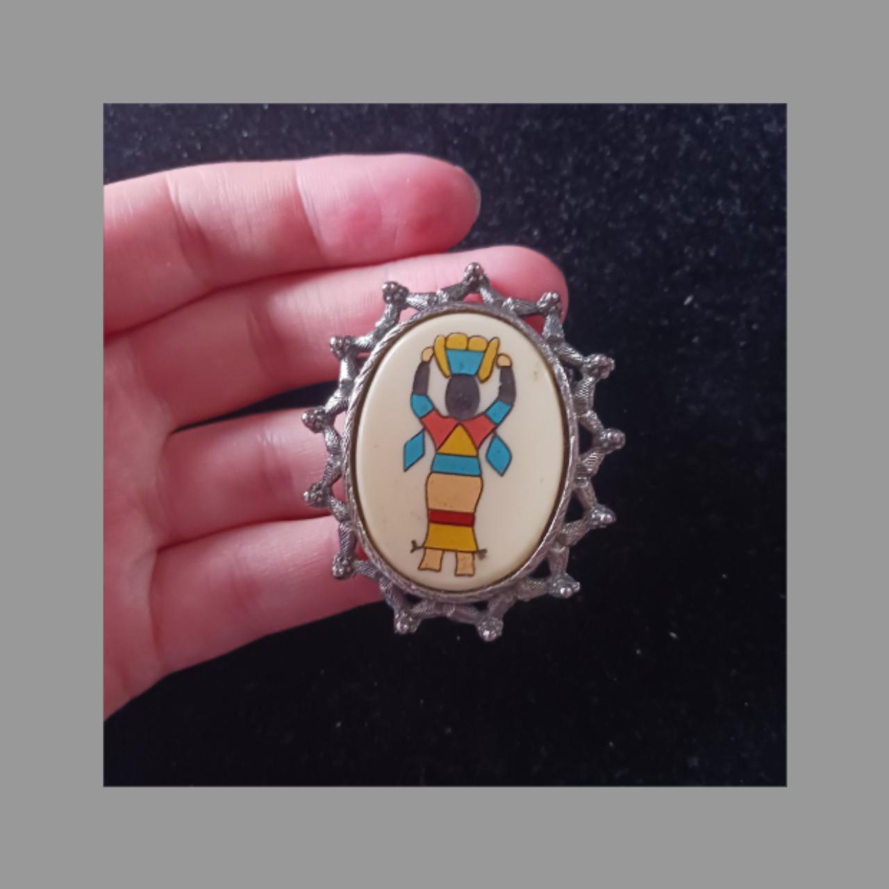 A Unique Vintage brooch featuring a person with a... - Depop