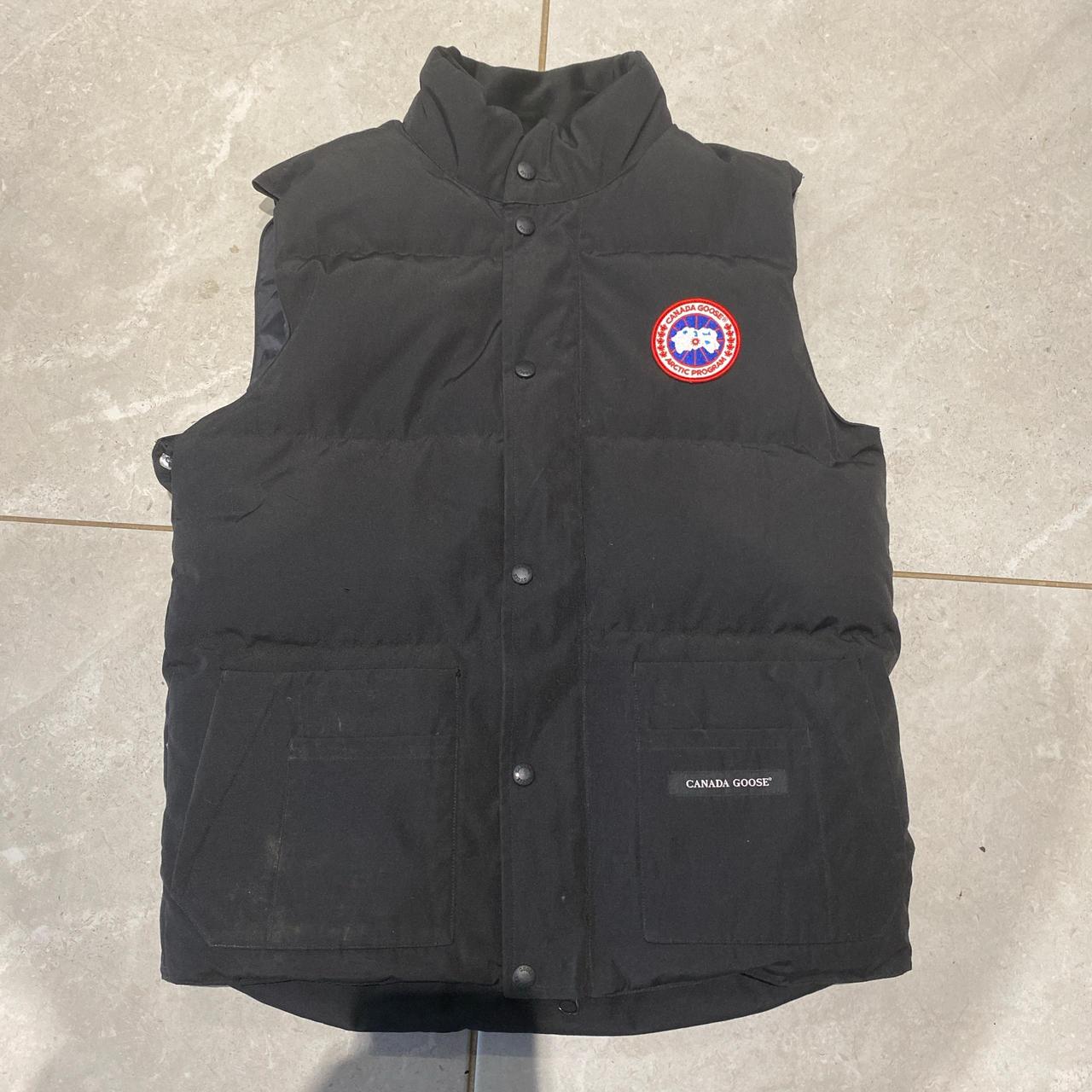 Canada Goose black gilet. Used with some wear. Rip... - Depop