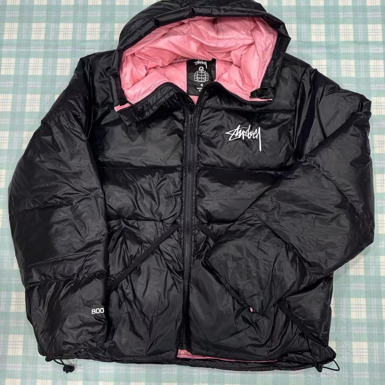 Black Stüssy puffer jacket with pink hood and... - Depop
