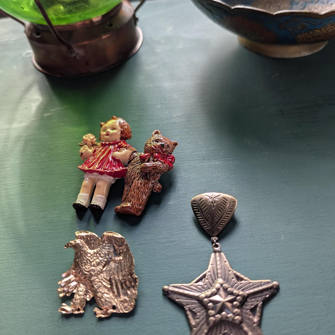 Assorted vintage metal pins, including a red and... | Depop