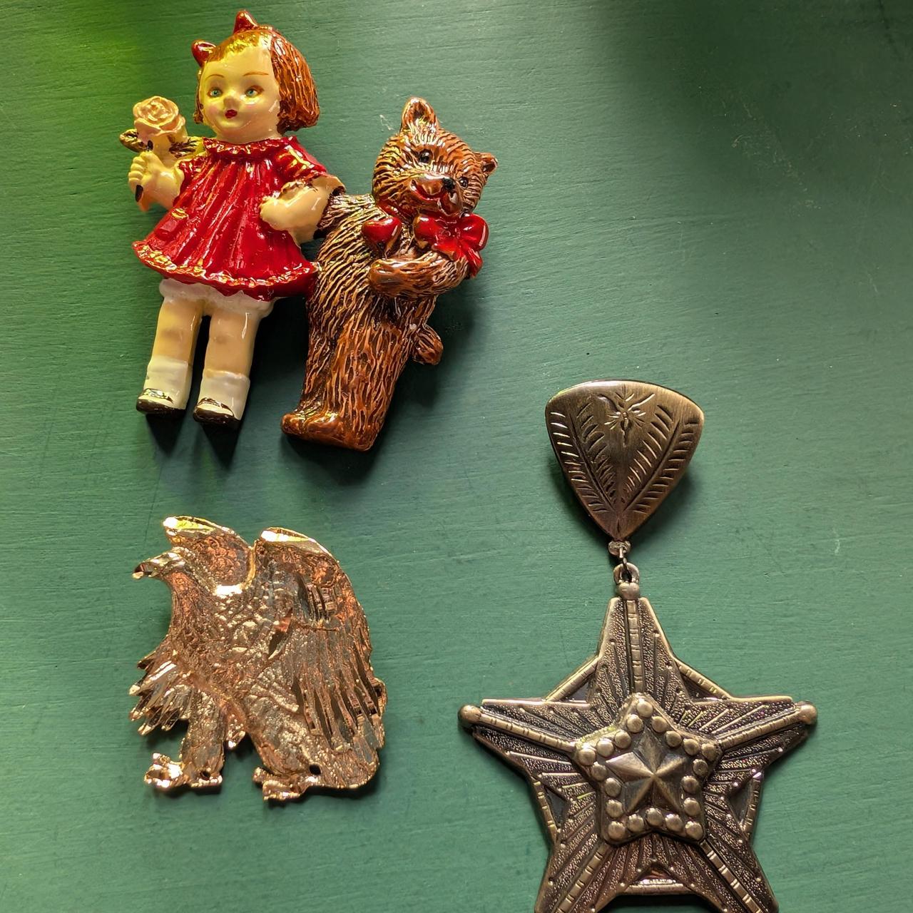Assorted vintage metal pins, including a red and... | Depop