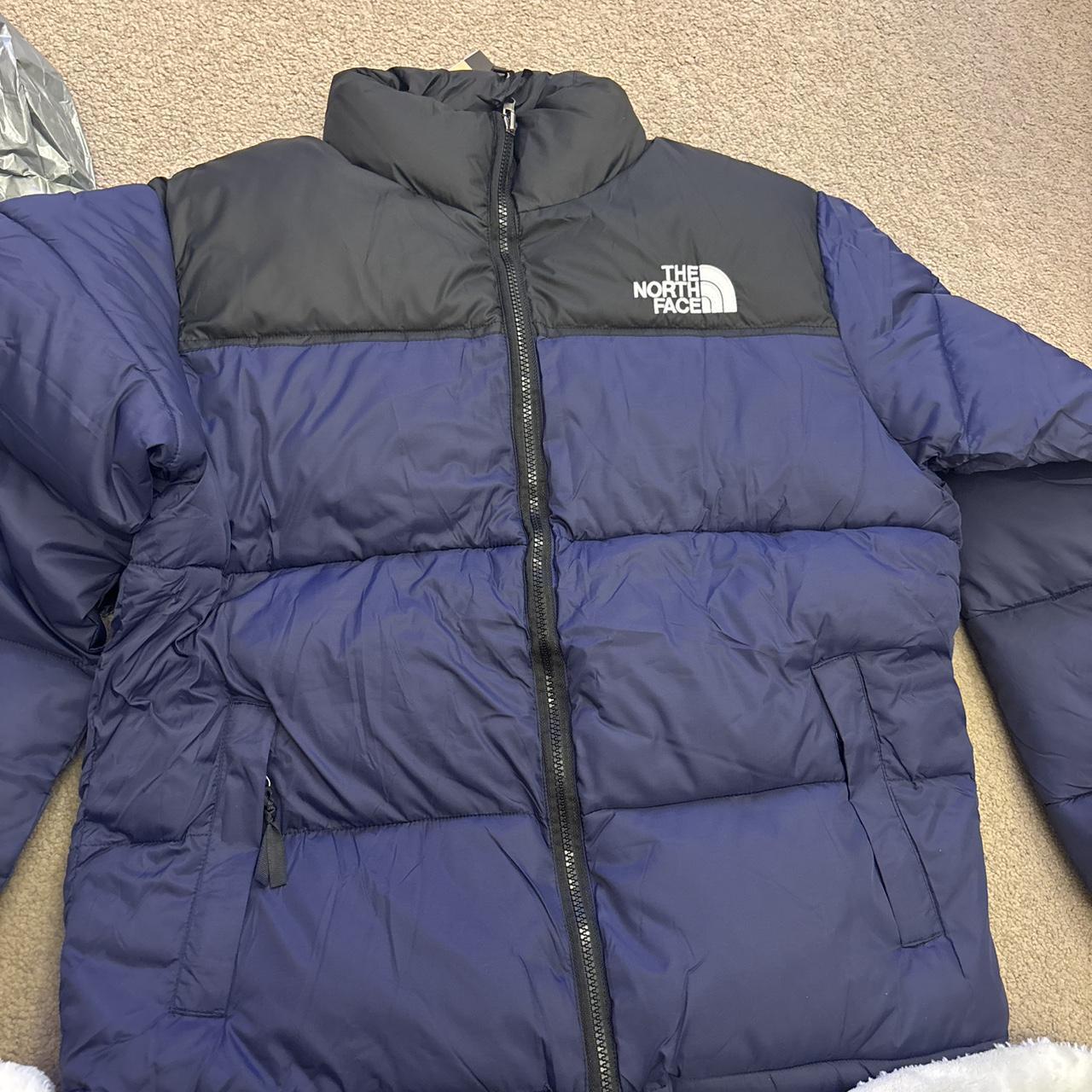 The North Face puffer jacket in blue and black... - Depop