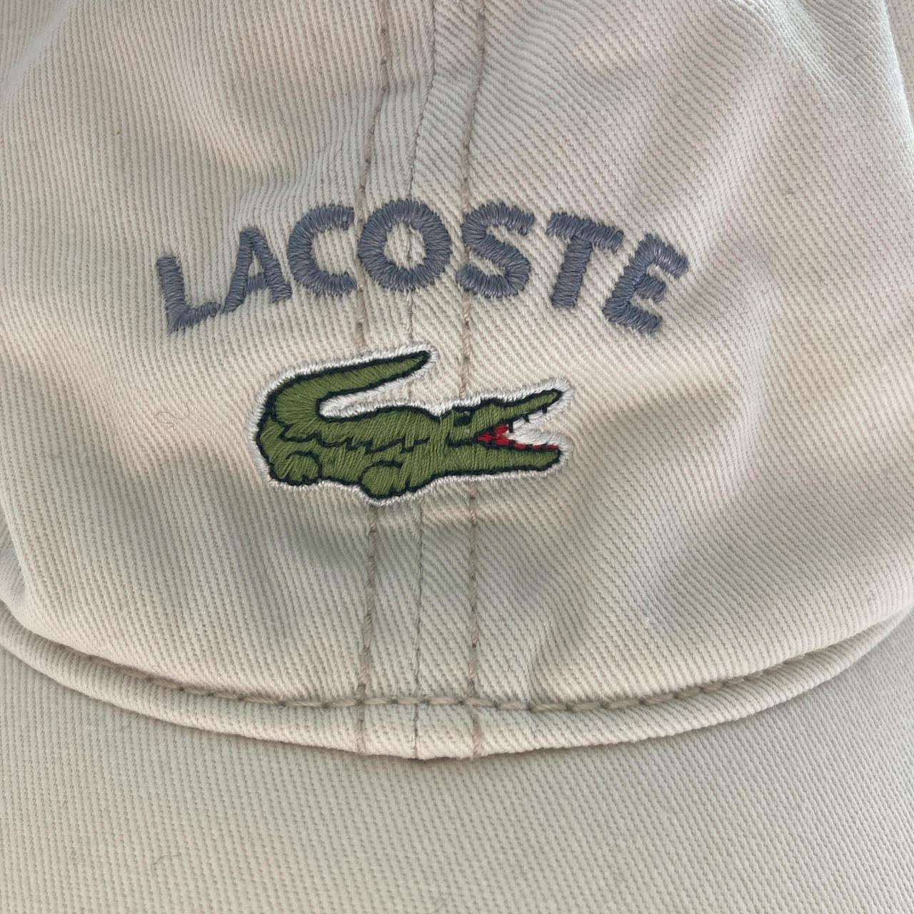 Lacoste cream cap, with grey/white stripes, some... - Depop
