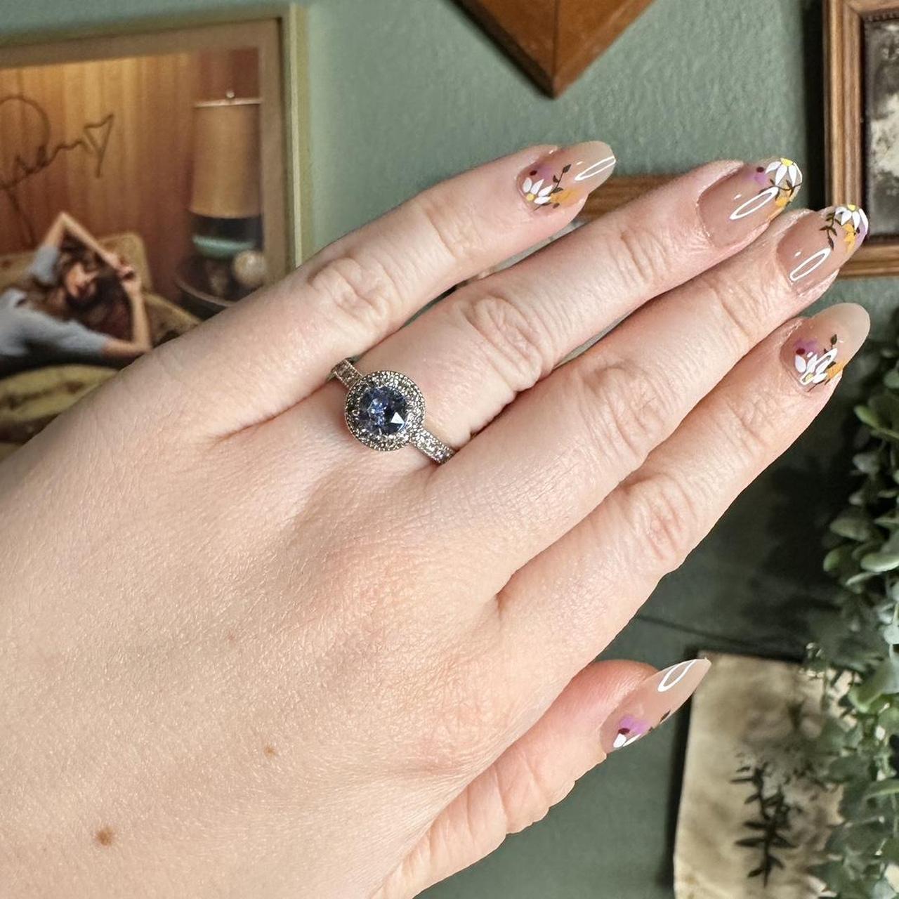 Silver toned ring with blue stone in center of tiny... - Depop
