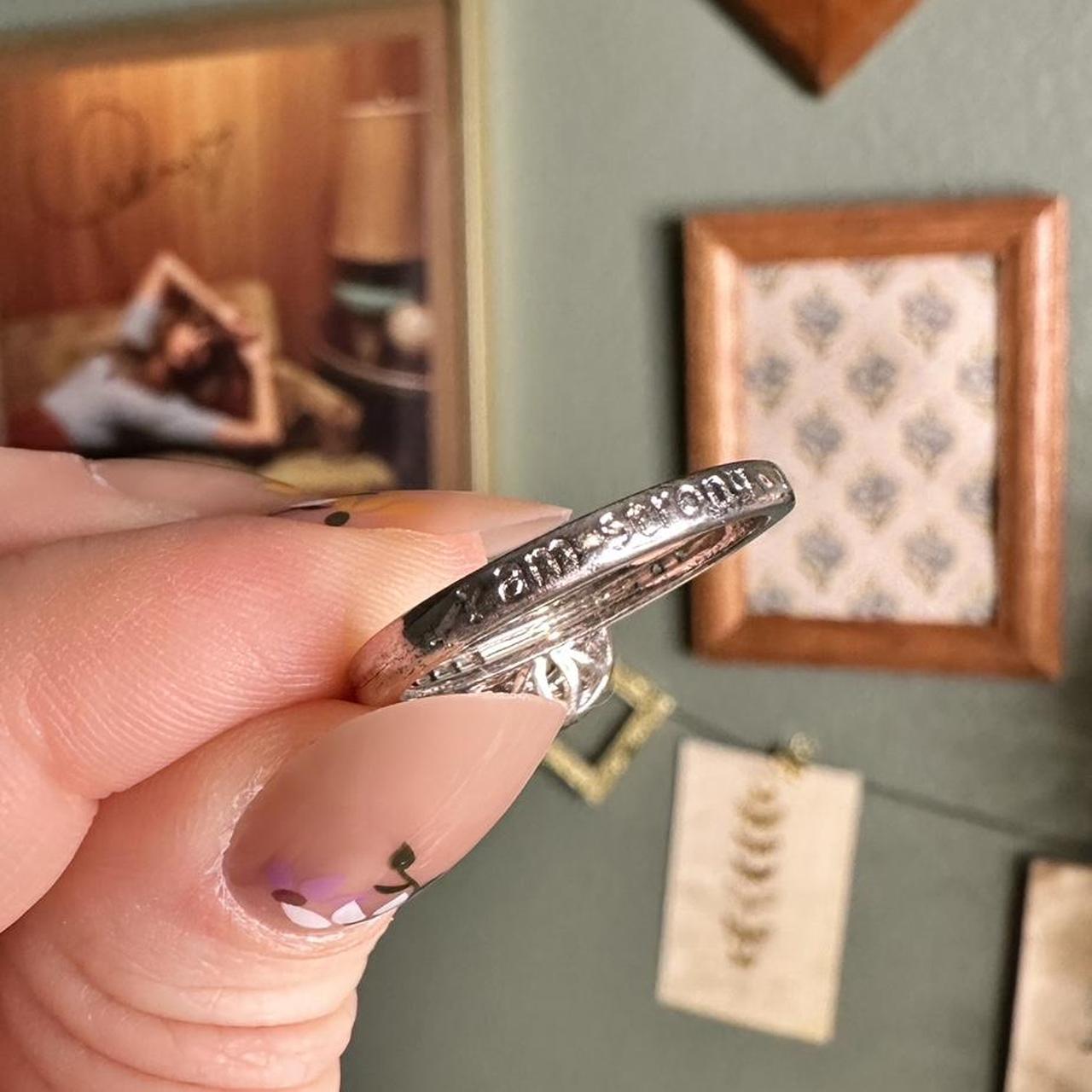 Silver toned ring with blue stone in center of tiny... - Depop