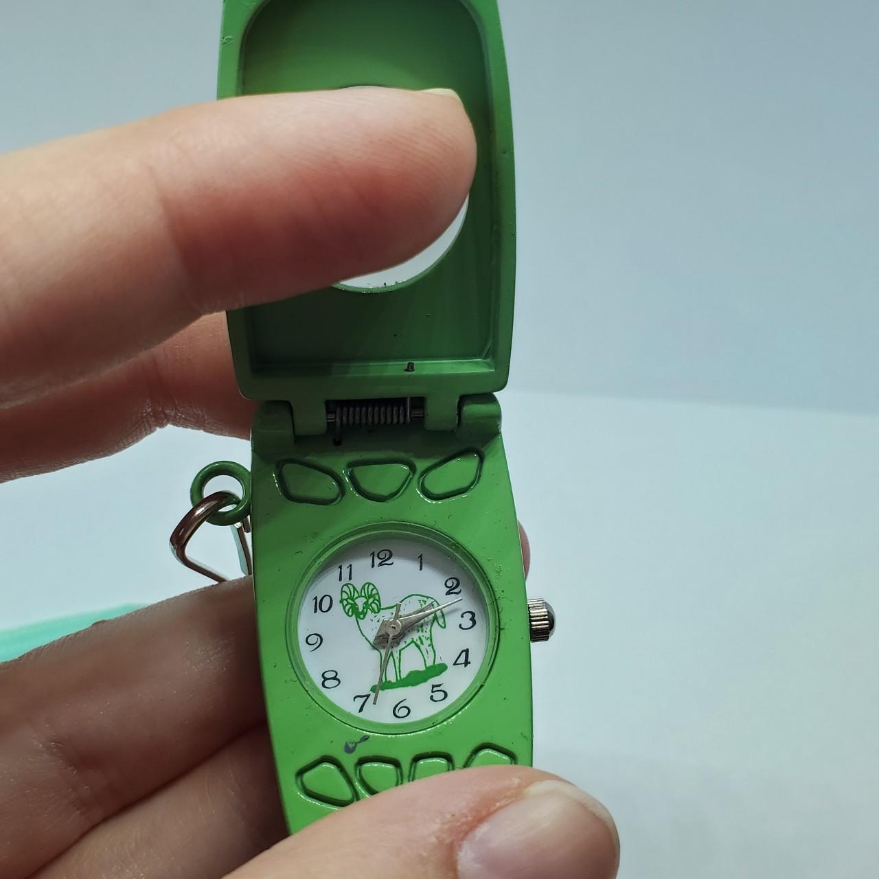 Early 2000s green enameled flip phone-shaped watch... - Depop