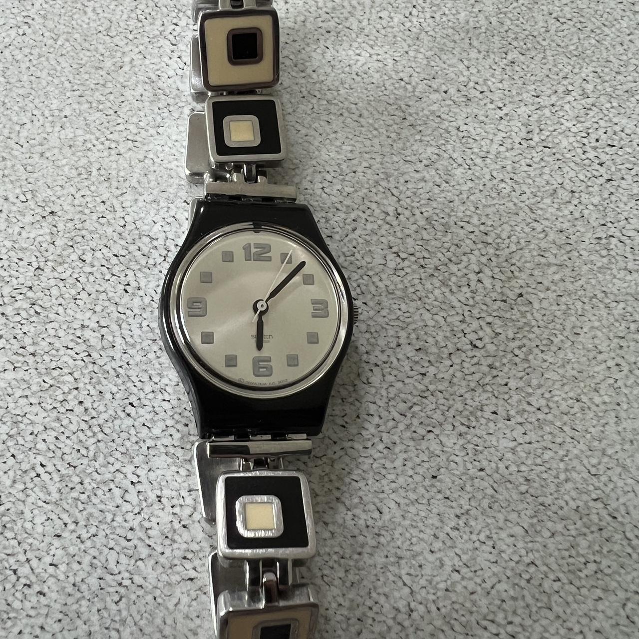 Silver Swatch watch with black and white ceramic detail - Depop