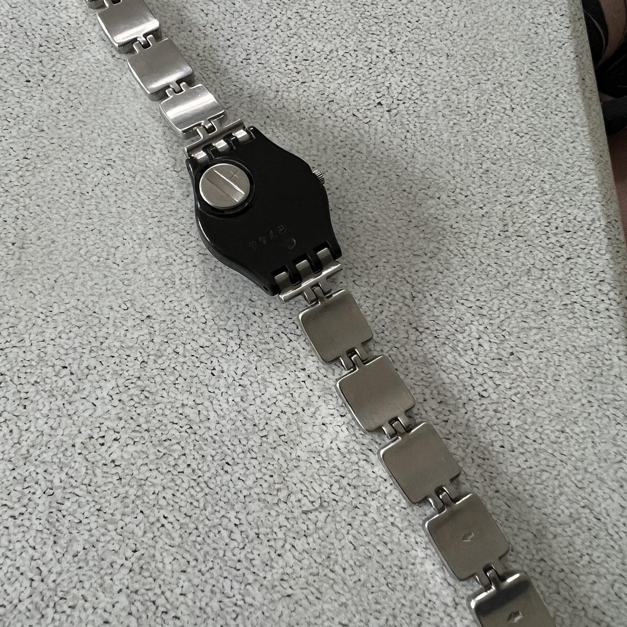 Silver Swatch watch with black and white ceramic detail - Depop