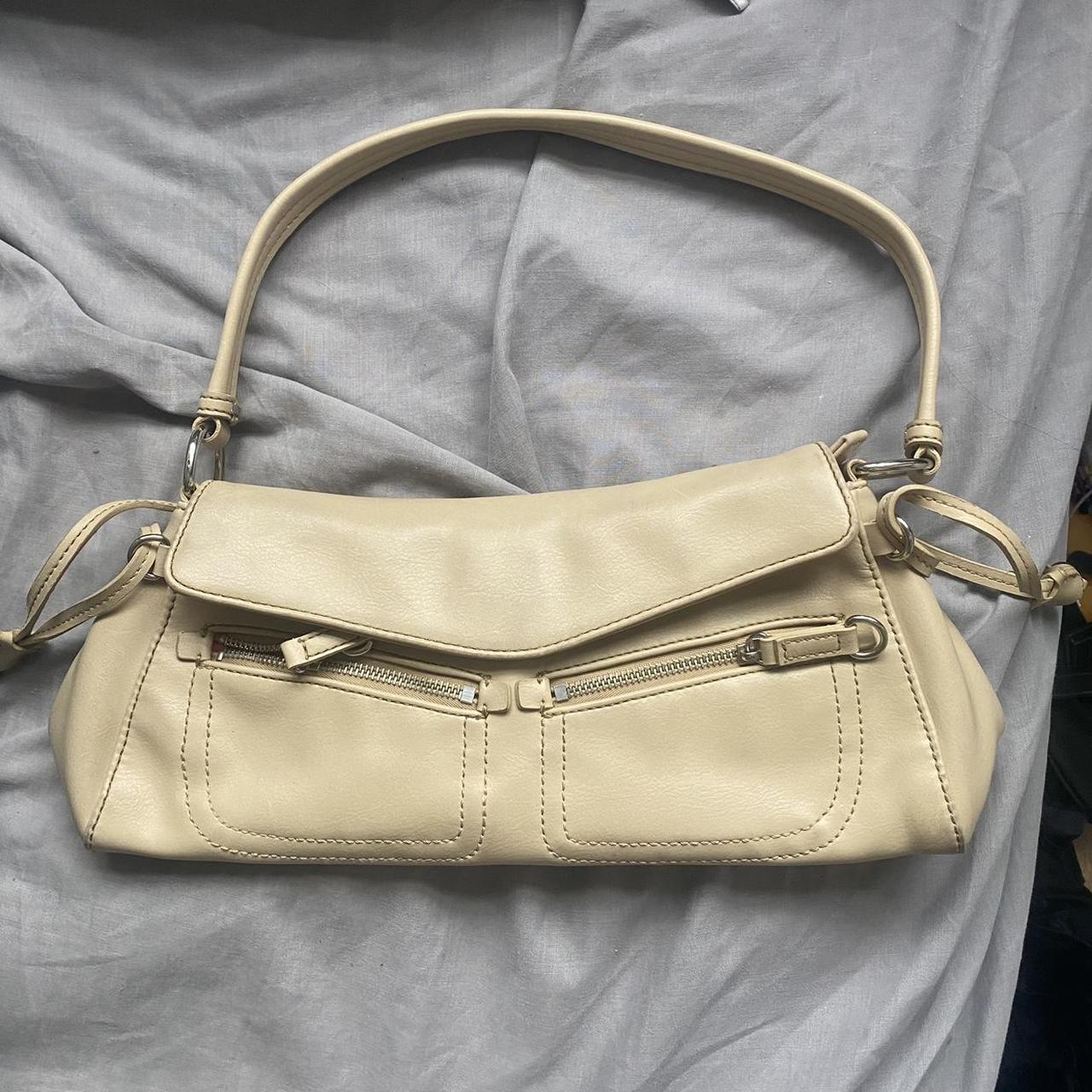 cream shoulder bag with two front pockets and... - Depop