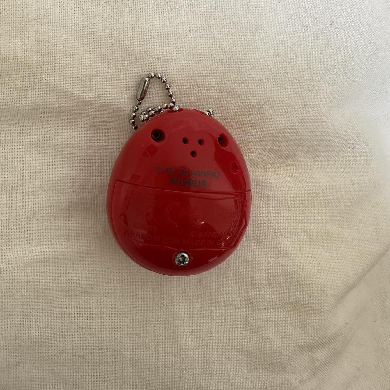 red hello kitty tamagotchi keychain some scratches... - Depop