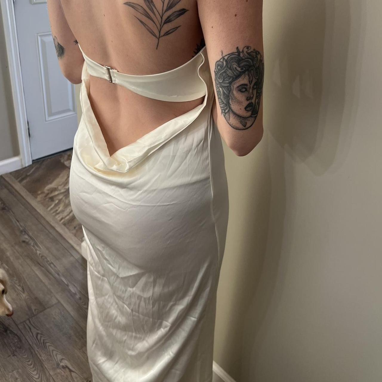 Off white satin maxi dress Clips in the back & has... | Depop