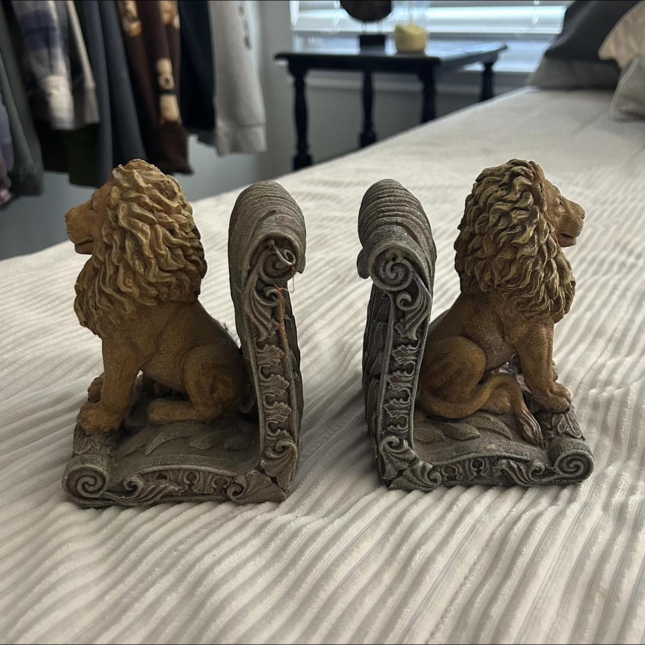 set of lion bookends a few tiny chips pictured... - Depop