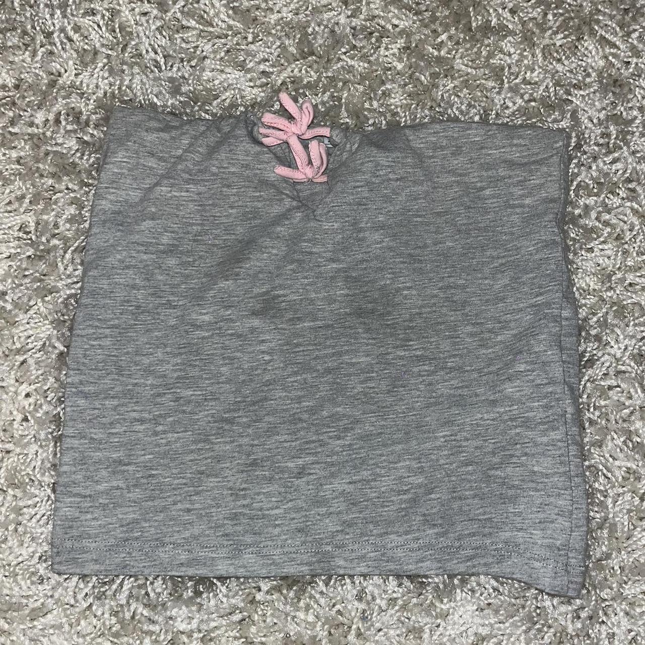 Subdued gray top with pink bows. Small stains on... - Depop