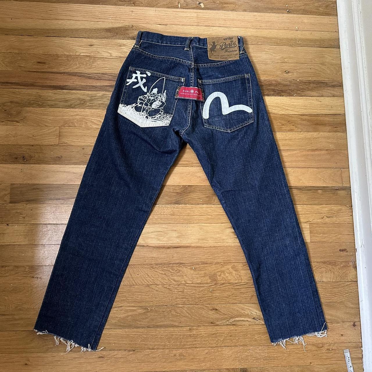 Evisu jeans with a unique design on the back pocket... - Depop