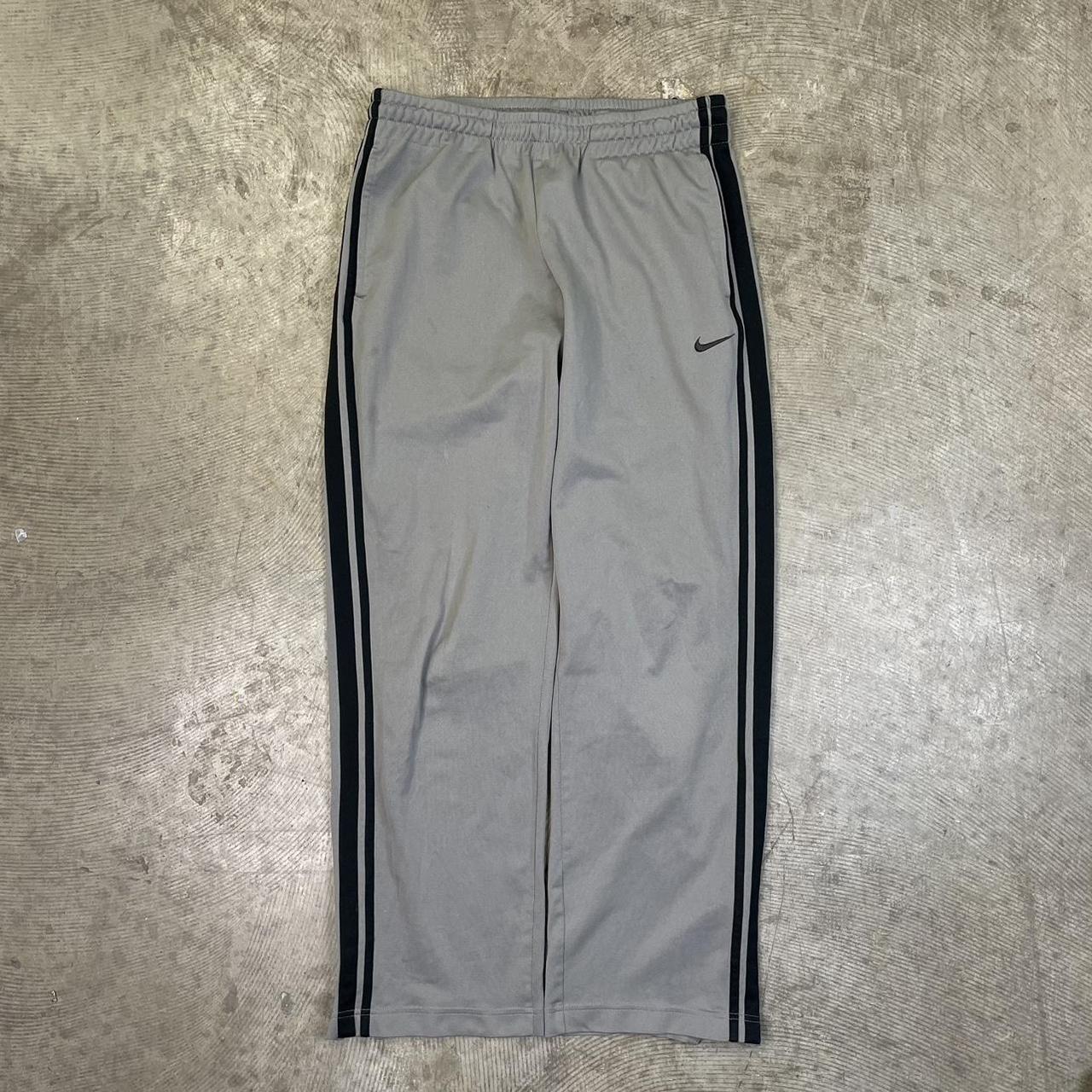 Nike baggy tracksuit bottoms joggers black size... - Depop