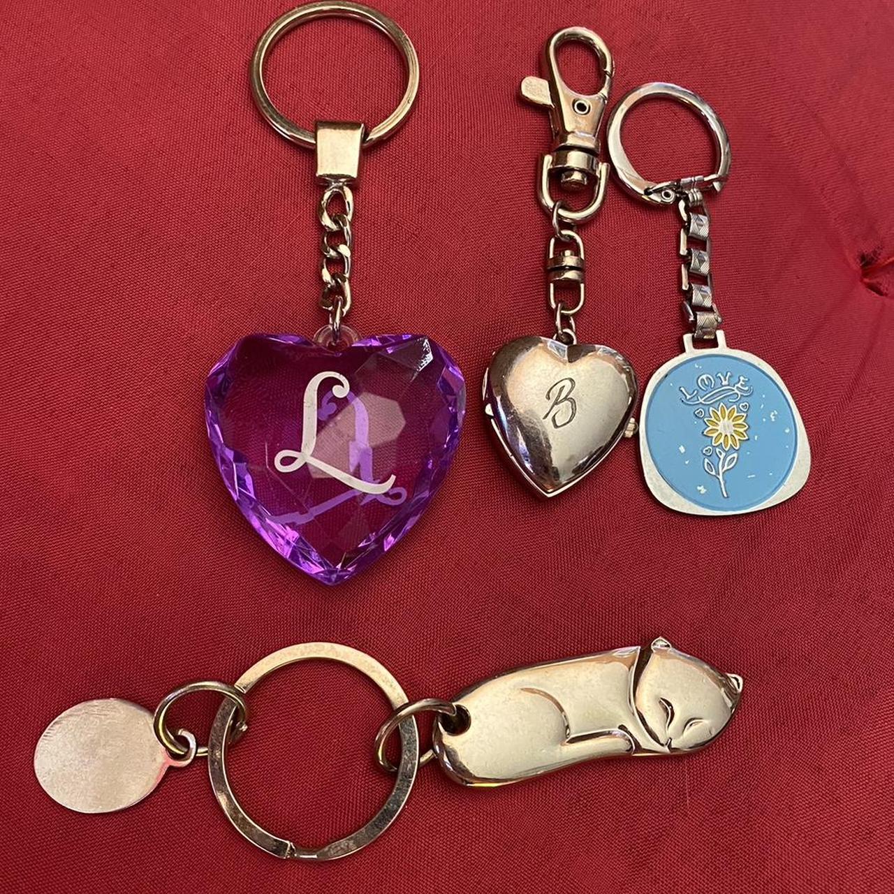 Bundle of y2k era keyrings 💜. Includes a purple L... - Depop