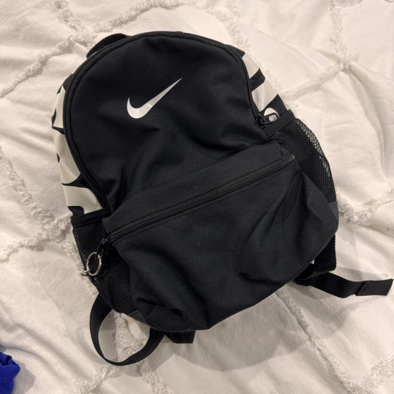 Black and white Nike mini backpack. Used well, but... | Depop