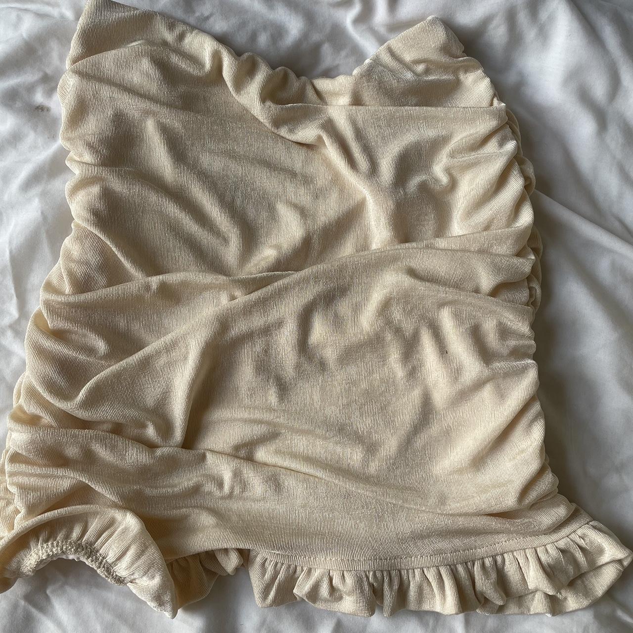 Cream mini skirt with ruched side. Super flattering... - Depop