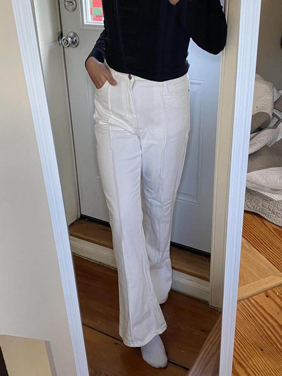 White bootcut jeans with a seam on the front of the... - Depop