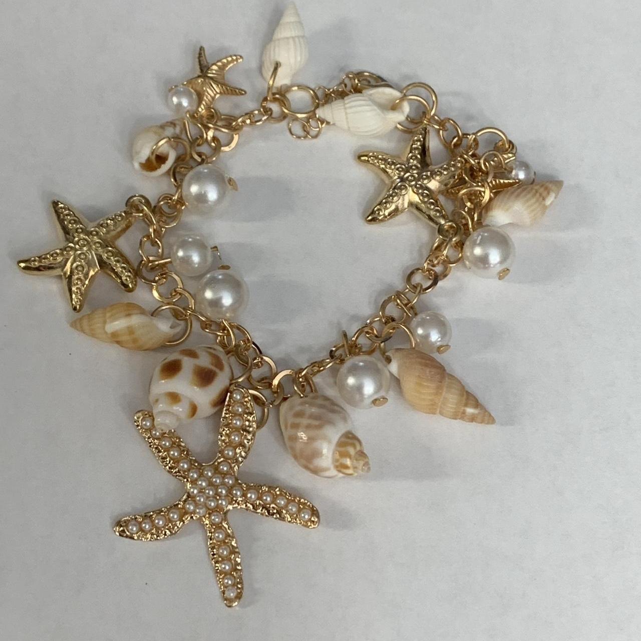 Gold tone starfish and seashell charm bracelet with... | Depop