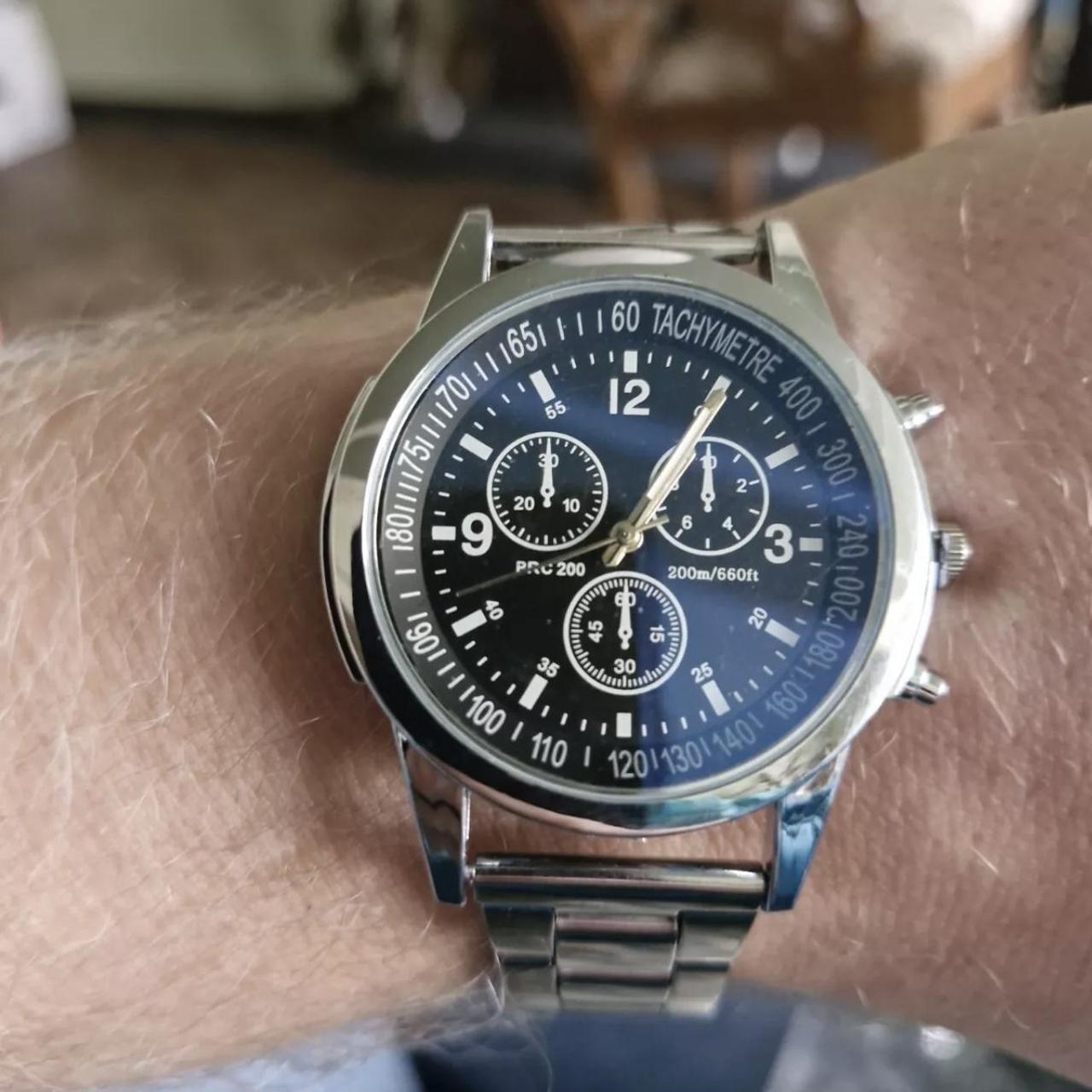 Silver analogue watch with date display, light... | Depop