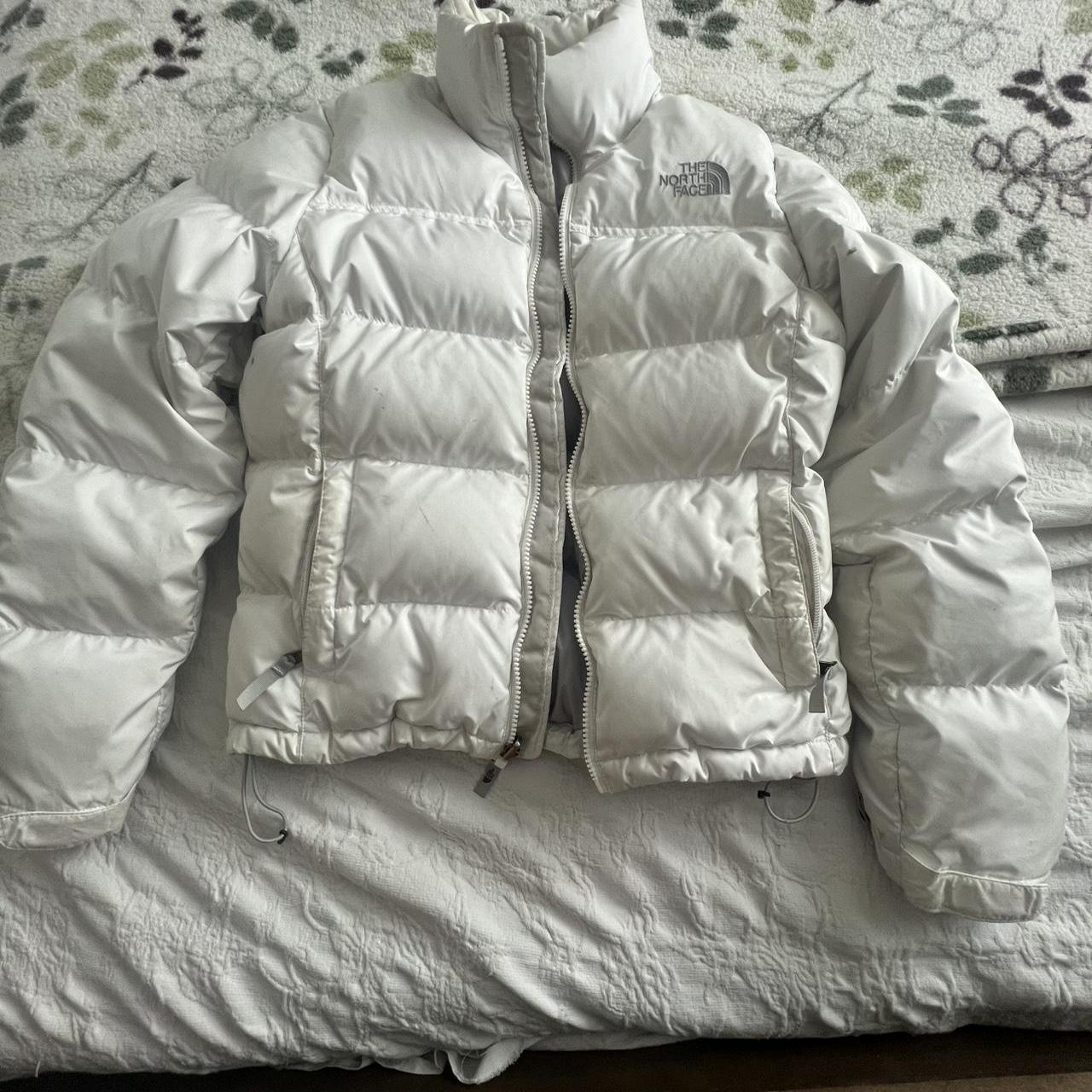 White North Face puffer jacket with a small stain on... | Depop