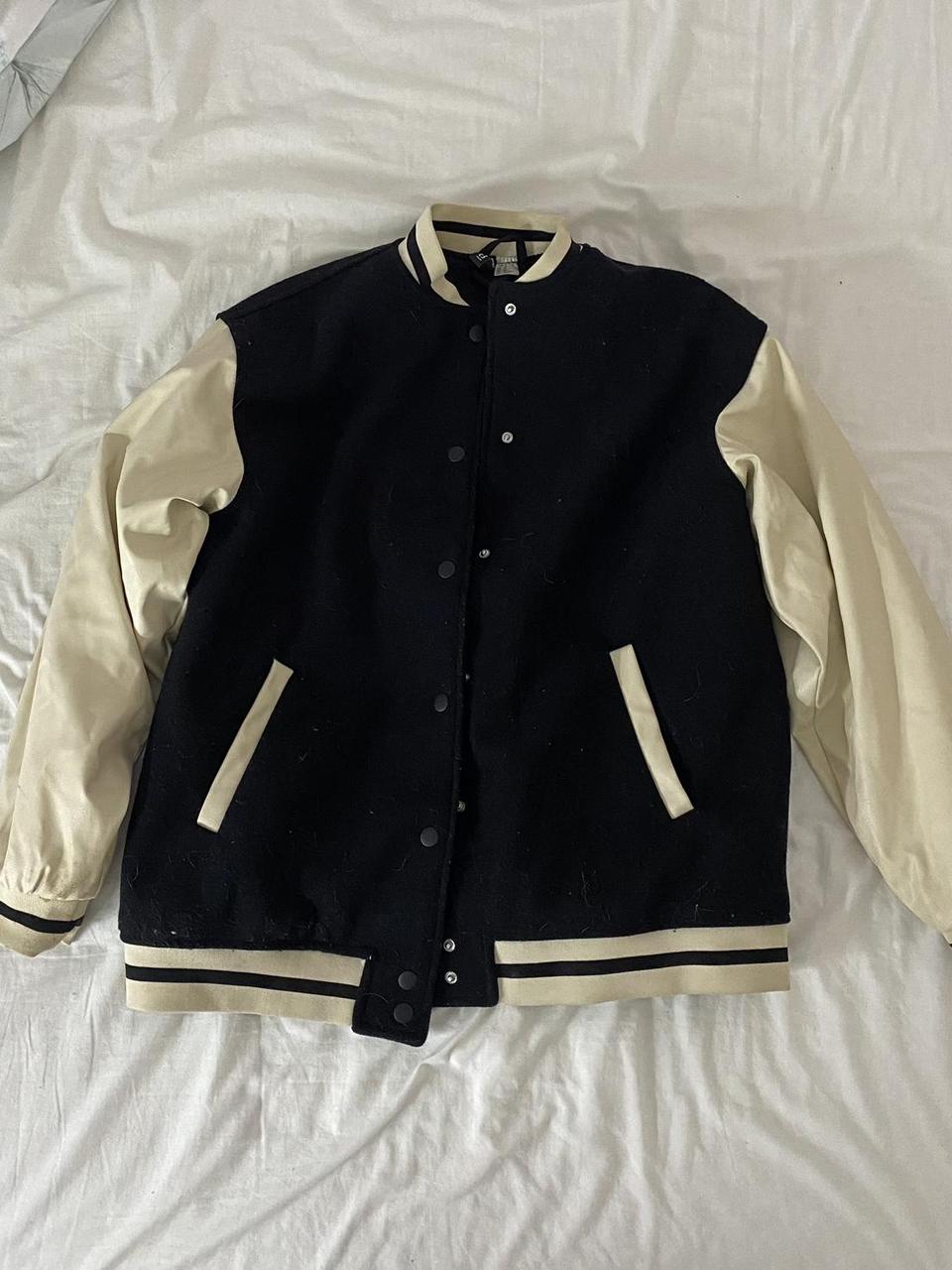 black and cream varsity jacket worn a few times,... - Depop