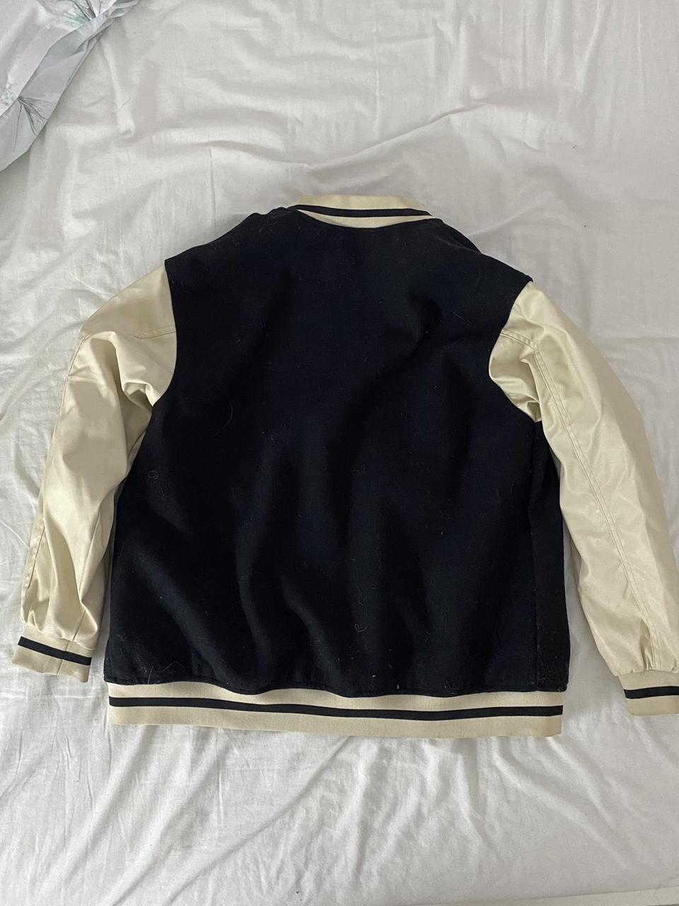 black and cream varsity jacket worn a few times,... - Depop