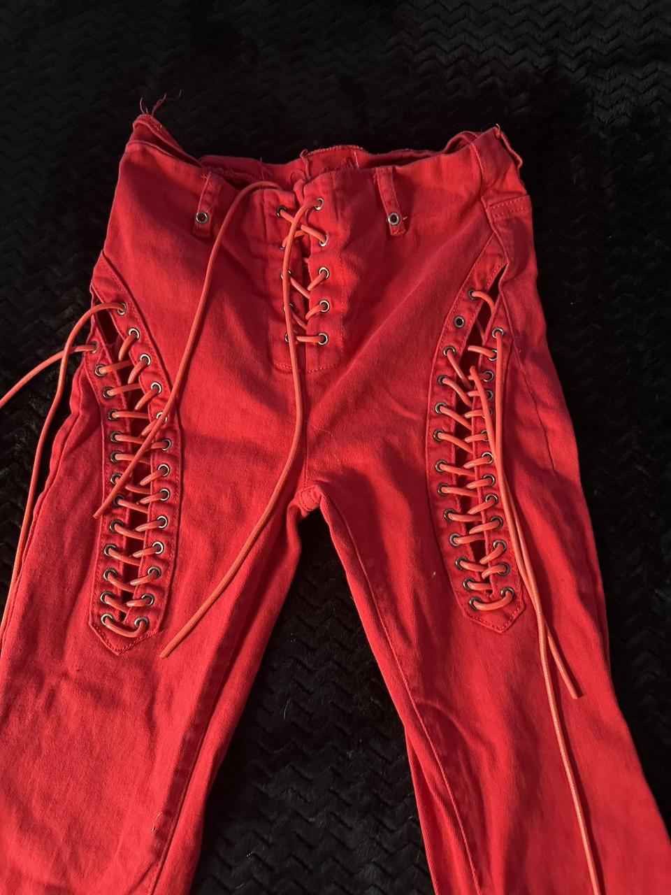 Red flare jeans with lace-up details... - Depop