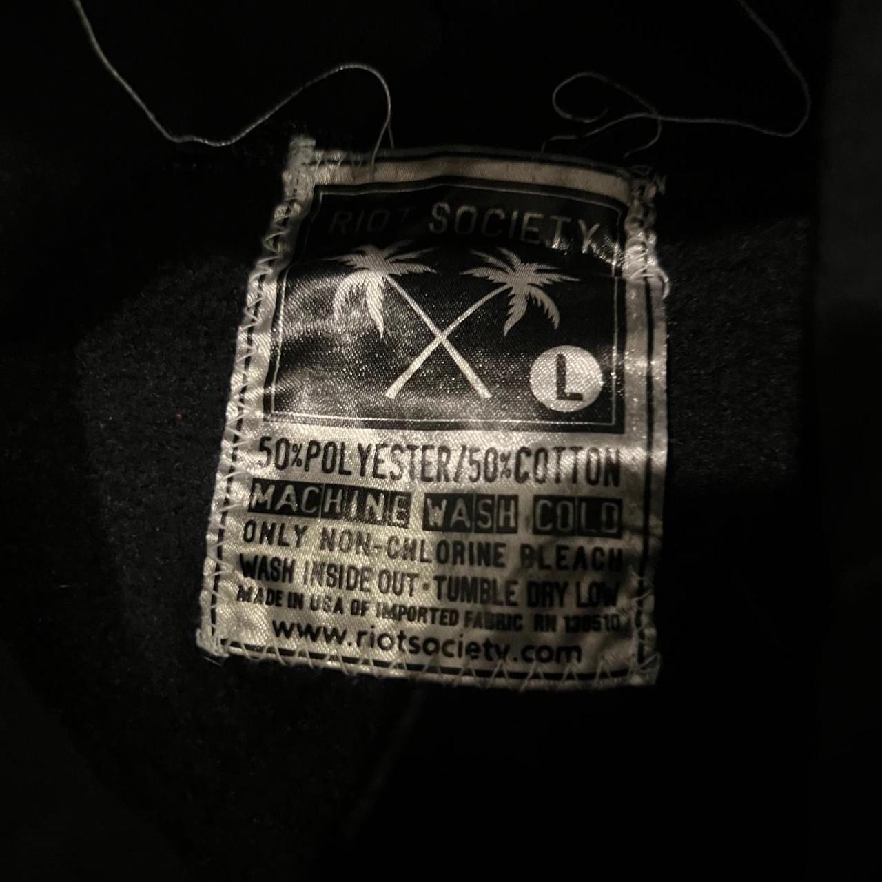 Black and blue Riot Society hoodie with skull logo... | Depop